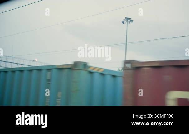 A freight train filmed from the window of a moving train. High quality ...
