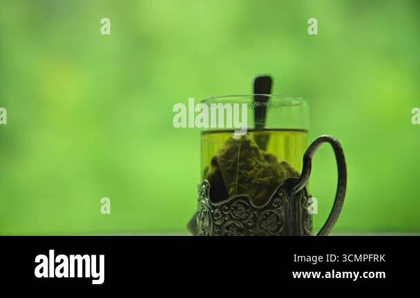 Green tea in a glass on a table in a moving train. High quality 4k ...