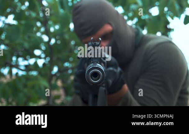 A professional military officer loads his armor and aims his machine ...