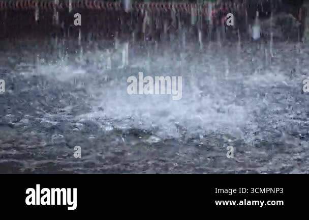 Heavy rain pours and water flows rapidly from the houses gutters ...