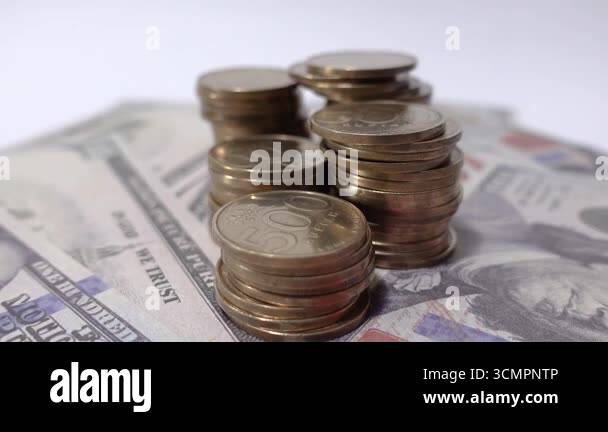 Close-up of coins neatly stacked on paper currency symbolize. The image ...