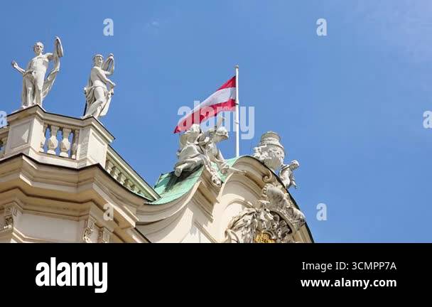 Vienna, Austria, May 3, 2025: Austrian flag waving atop an ornate ...