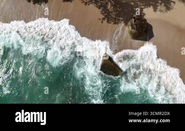 Giant ocean waves crashing and foaming on empty sand tropical beach ...