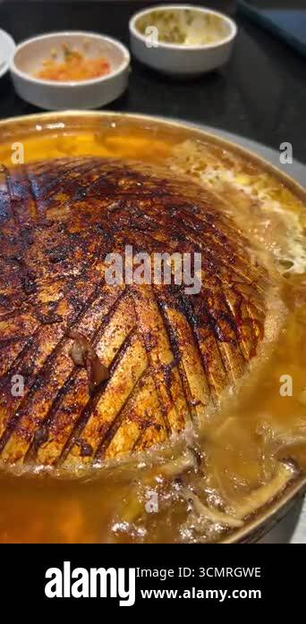 4K close up video of Thai BBQ Mookata style, grilling pork and beef on ...