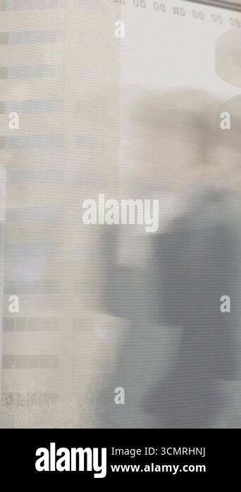 Binary code animation overlaying people working in office building ...