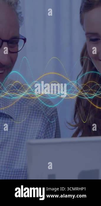 Smiling colleagues discussing data on tablet with colorful wave ...