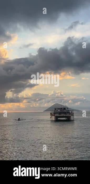 Luxury Yacht in Port Manado Bay, North Sulawesi at sunset. vertical ...