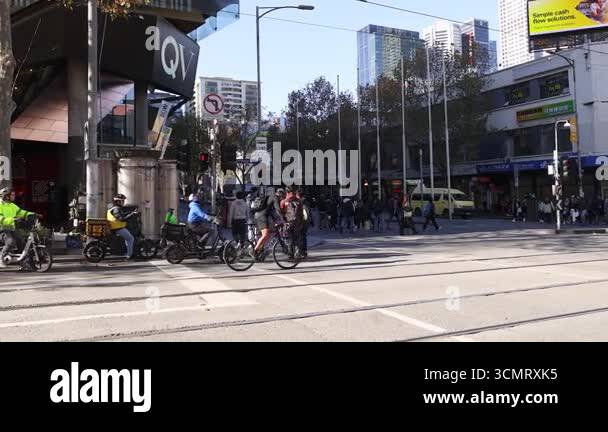 People crossing road, cyclists waiting at intersection Stock Video ...