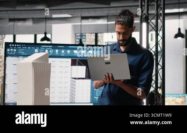 Male real estate engineer studying smart city design and buildings ...