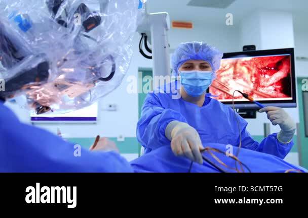 Uniformed female scrub nurse untangles the wires of surgical tool ...