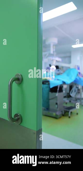 Slider door opened to the surgery room. Unrecognized doctor works at ...