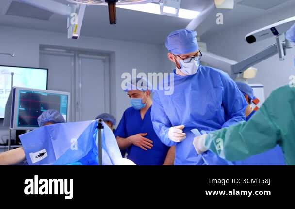 Medics cover the patient with blue sheets before surgery. Operational ...