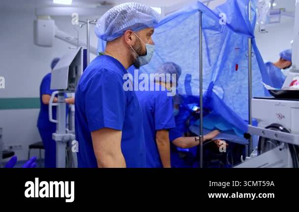 Operation on brain is taking place in a modern hospital. Male ...
