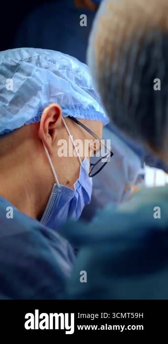 Surgeons at work. Medical professionals focus intently as they perform ...