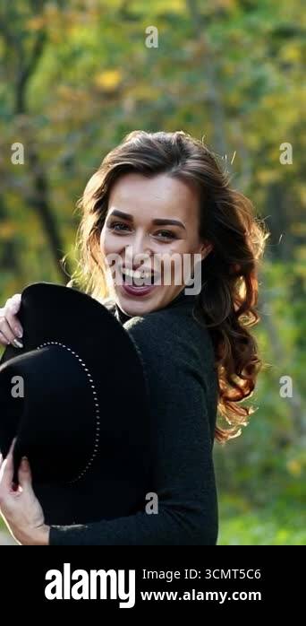 Beautiful female dreaming in the autumn park. Cheerful beautiful girl ...