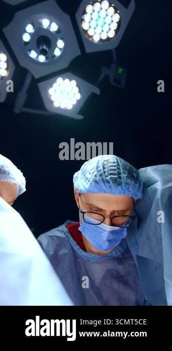 Surgeon focused in surgery. In a sterile operating room, a surgeon ...