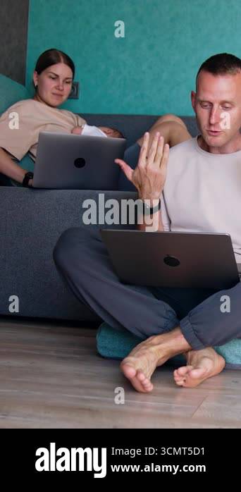 Caucasian married couple working remote at home. Parents of a newborn ...