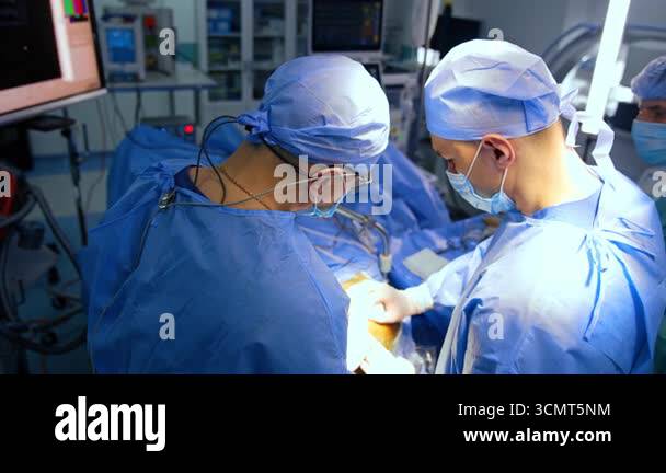 Rear high angle view on the male Caucasian surgeons working at ...