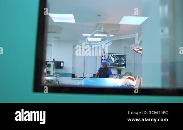 Surgeon ready for surgery. A medical professional is seen in scrubs ...