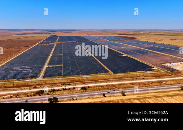 Solar farm in vast open landscape. Vast solar panels stretch across an ...