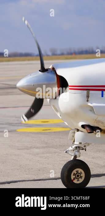 Front part of white aircraft with red lines. Little plane with rotating ...