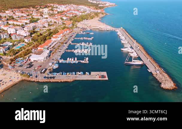 Coastal marina with boats in clear water. View of a vibrant marina ...