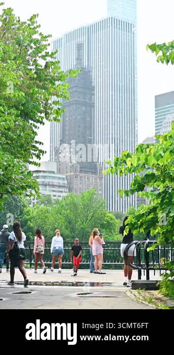 Exploring Central Park on a sunny day. Visitors stroll through Central Park, enjoying warm ...