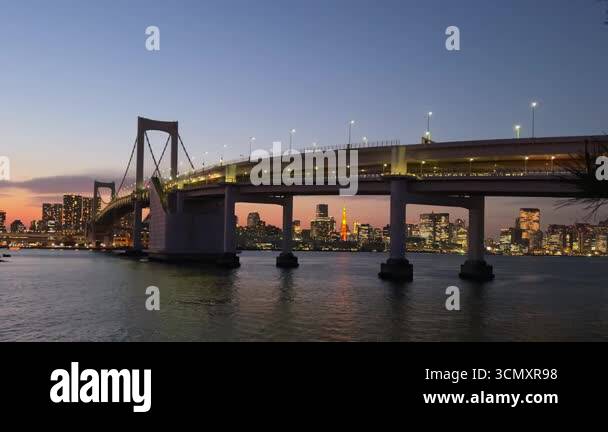 Tokyo Rainbow Bridge at sunset with Tokyo cityscape in the background ...
