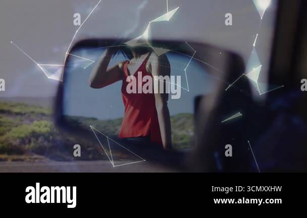 Car mirror reflecting woman shading eyes initiating tech overlay ...