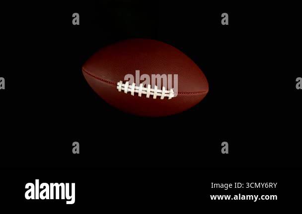 Super Slow Motion of Falling American Football Ball on Black Background ...