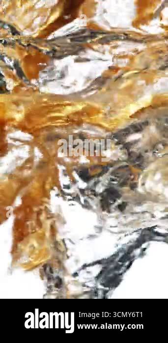 Super slow motion of rotating golden paint in water. Filmed on high ...