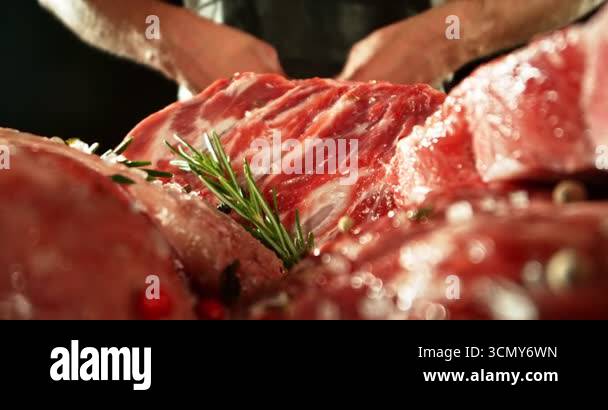 Super Slow Motion of Chef Throwing Salt and Spice on Raw Meat. Filmed ...