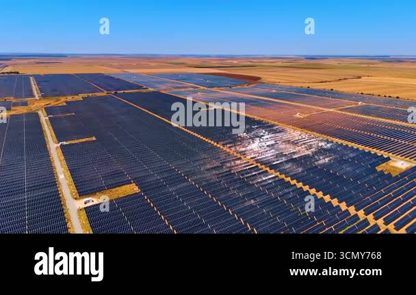 Solar station on wide arid land. Photovoltaic solar panels arranged in ...