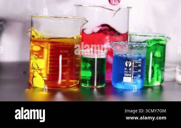 Beakers with colorful liquids and dry ice reaction Stock Video Footage ...