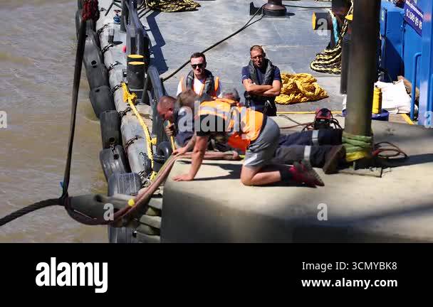 Man in life jacket working on dock Stock Video Footage - Alamy