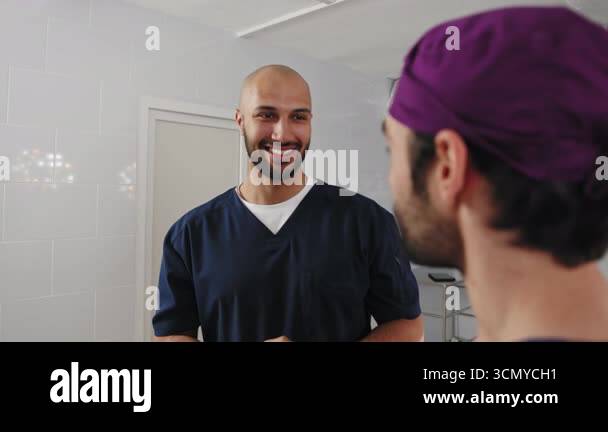 Two medical professionals converse in a hospital setting, possibly ...