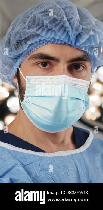 Close-up shot of a medical professional, wearing a surgical mask and ...