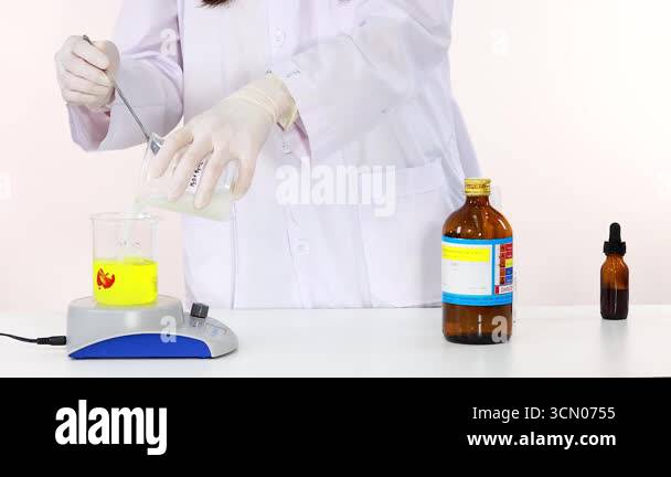 Scientist conducting iodine clock reaction experiment in laboratory ...