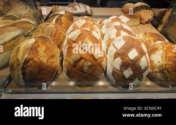 Sourdough bread in a glass display case in a supermarket Stock Video ...