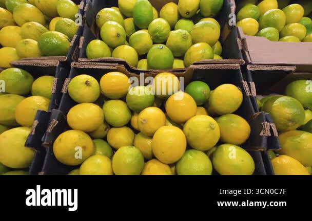Lemons and limes in cardboard boxes at the supermarket Stock Video ...