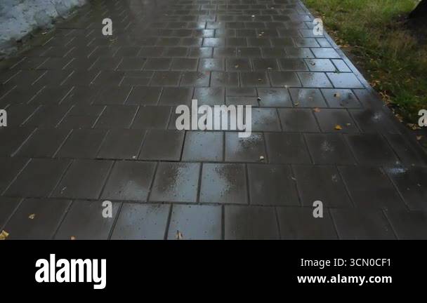 Wet street tiles during rain Stock Video Footage - Alamy