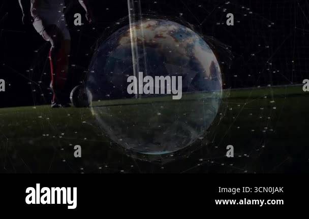 male soccer player tapping ball and kicking as technology globe forming ...