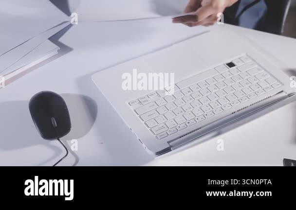 close - up view of businessman using computer and laptop on desk in the ...
