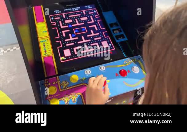 Dubai, UAE, 9 june 2025. Child playing classic Ms. Pac-Man on arcade ...