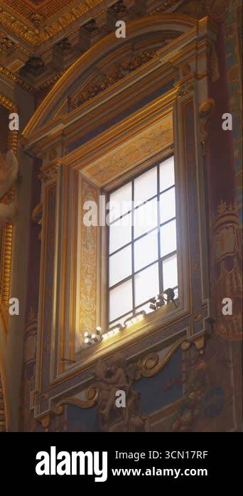 Baroque window with golden ornate frame, arched pediment, and ...