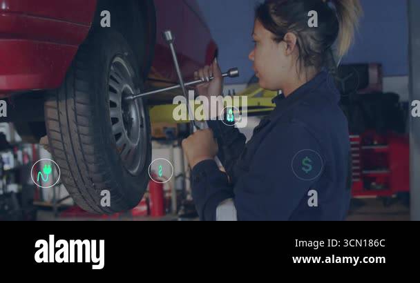 Female mechanic aligning lug wrench and loosening wheel nuts in auto ...
