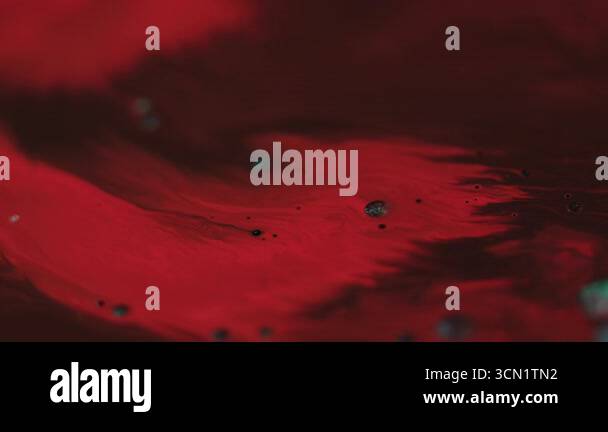 Ink pouring. Drip background. Defocused red crimson color paint oil ...