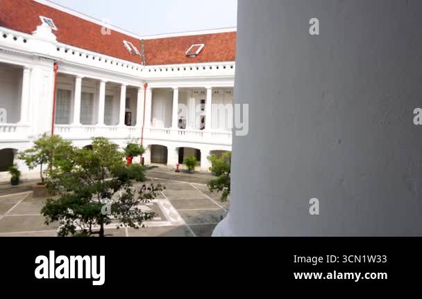 Slow Motion Pan of a White Dutch Colonial Building with White Columns ...