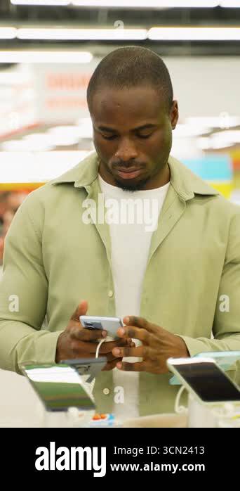 Young african american male exploring new smartphone features and apps ...