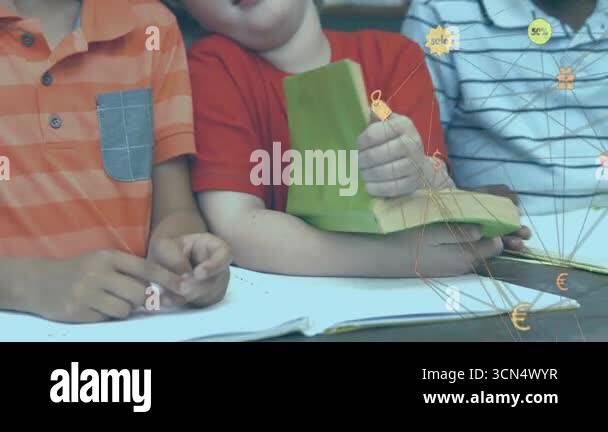 Red-shirted boy lifting green book reading while peers paging notes ...